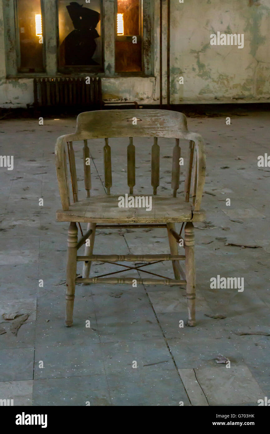 Wooden chair sitting in empty room of decaying Ellis Island room Stock ...