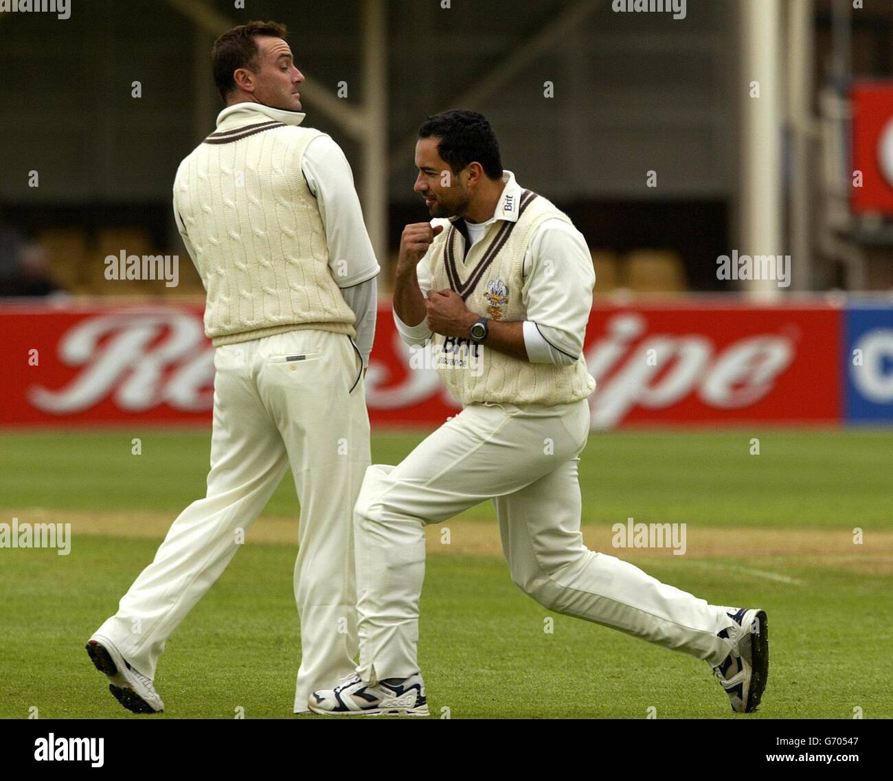 Surrey's Graham Thorpe (left) keeps his chin away from his former ...