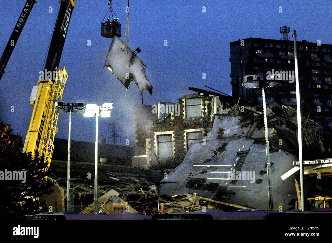 The roof is removed from the scene of a collapsed plastics factory ...