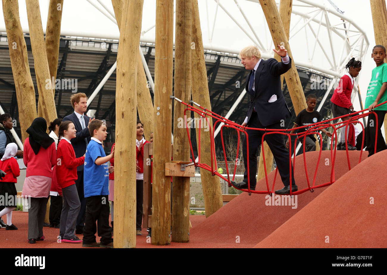 Prince Harry watches as Mayor of London Boris Johnson walks over a rope ...