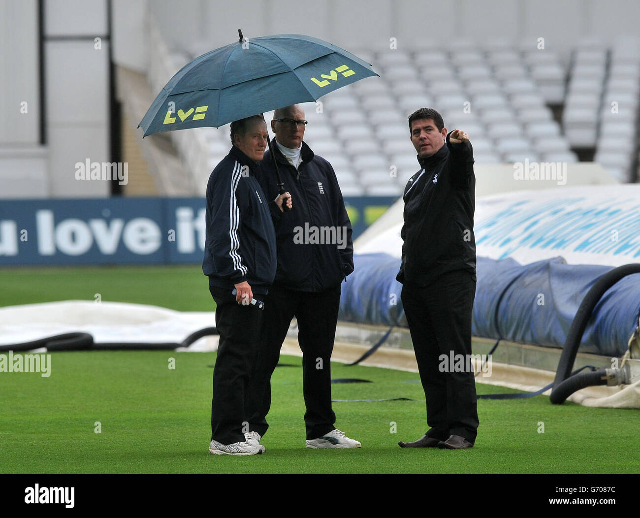 Umpires Stephen Gale (left) and Neil Mallender inspect the pitch as ...