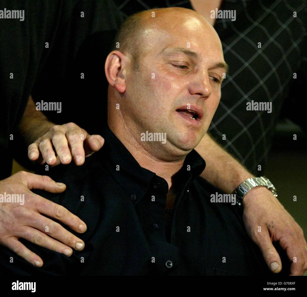 Terry Smoker is consoled at a press conference held at Haywards Heath ...