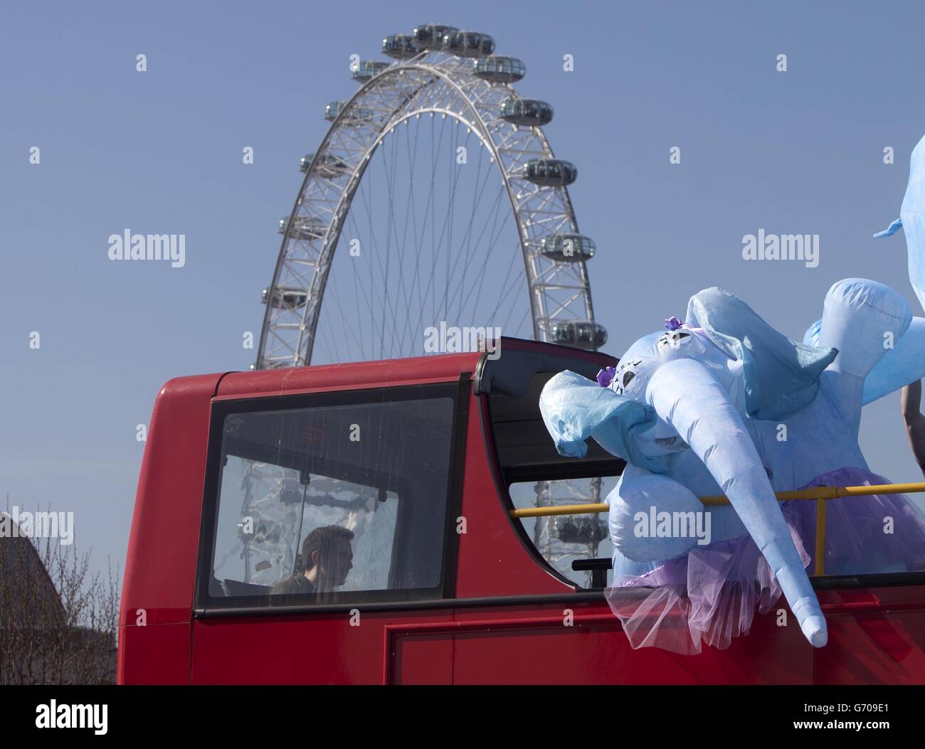 An open-top bus transports some of the cast of The Elephantom from ...