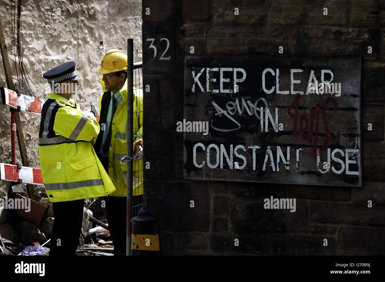 A policeman stands at the gates of a derelict building on Edinburgh's ...