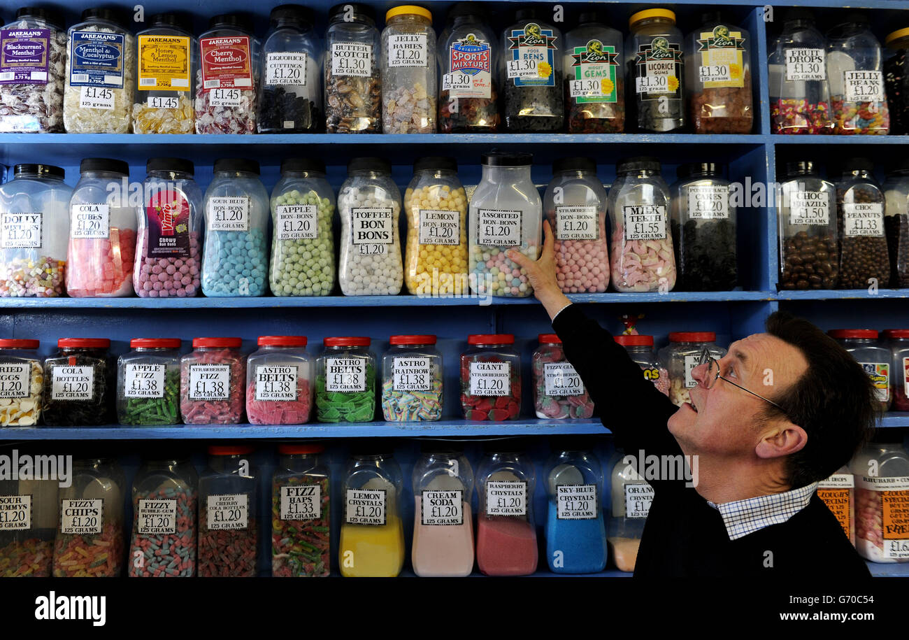 Alan Clough picks out some sweets in his shop Clough's of Heaton as he ...