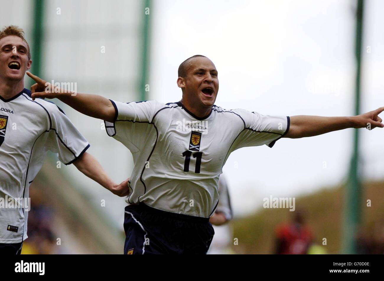 Scotland's Nigel Quashie celebrates with team-mates after scoring ...