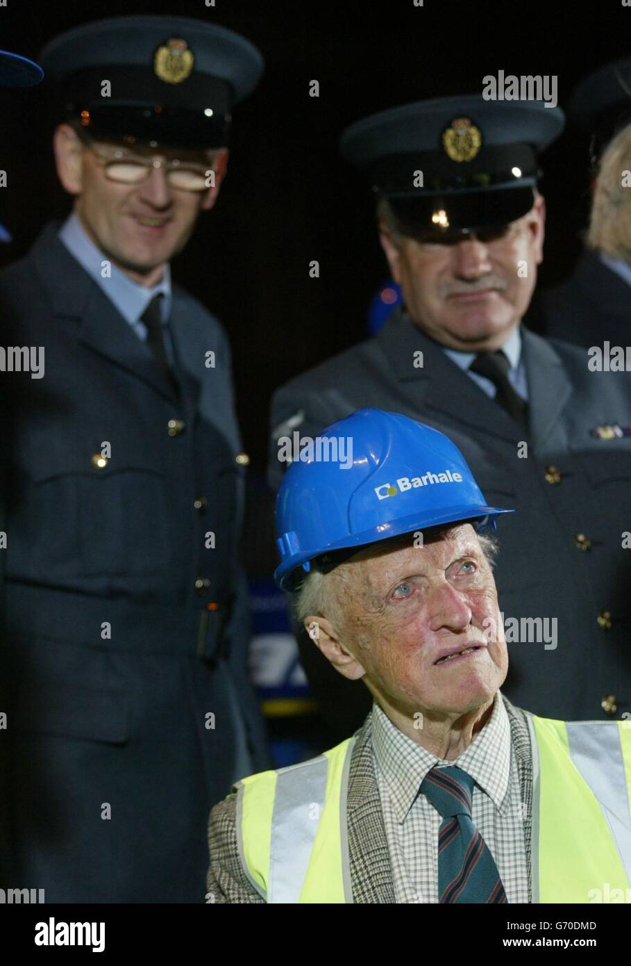 Second World War pilot Sergeant Ray Holmes (R), looks at a peice of the ...