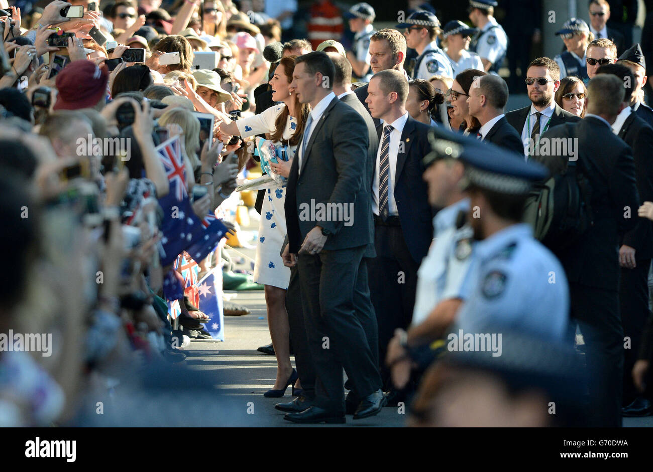 The Duchess of Cambridge is surrounded by security guards following an ...
