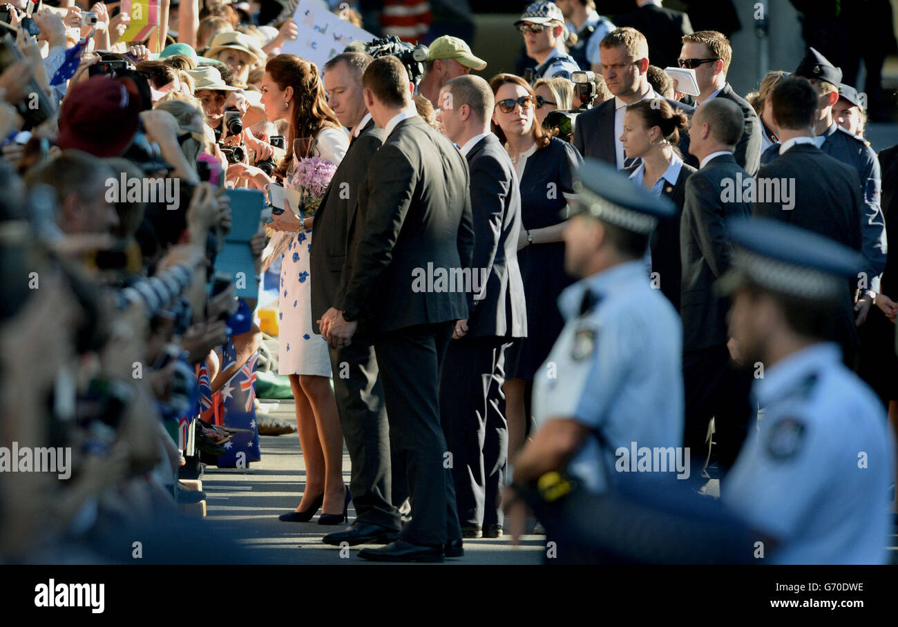 The Duchess of Cambridge is surrounded by security guards following an ...