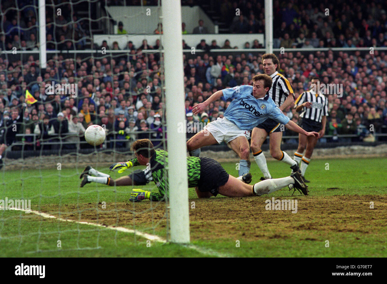 Notts County goalkeeper Steve Cherry saves at the feet of Manchester ...