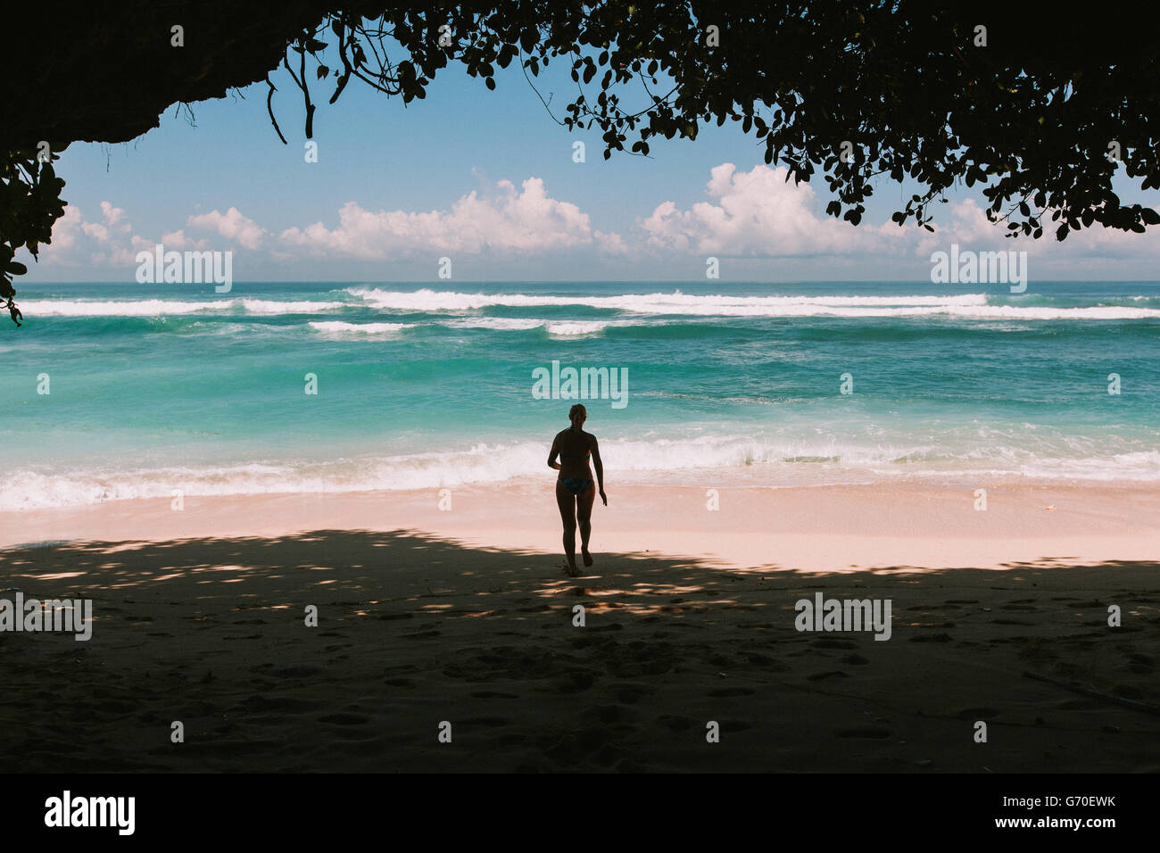 Girl running into the ocean Stock Photo - Alamy
