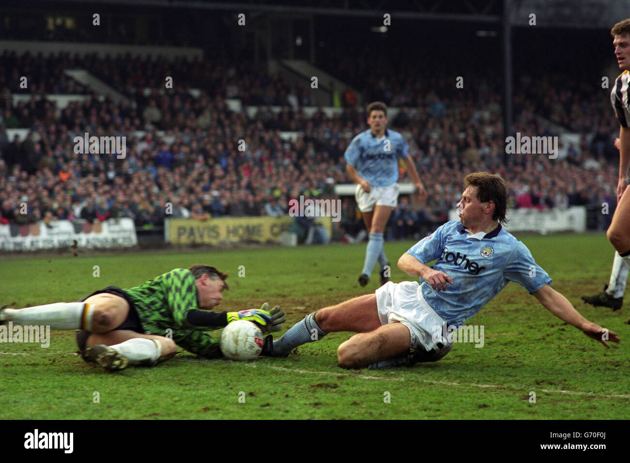 Notts County goalkeeper Steve Cherry saves at the feet of Manchester ...