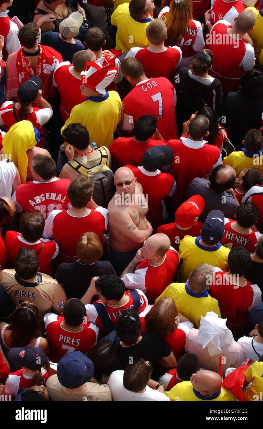Fans wait for the Arsenal team display the Barclaycard Premiership ...