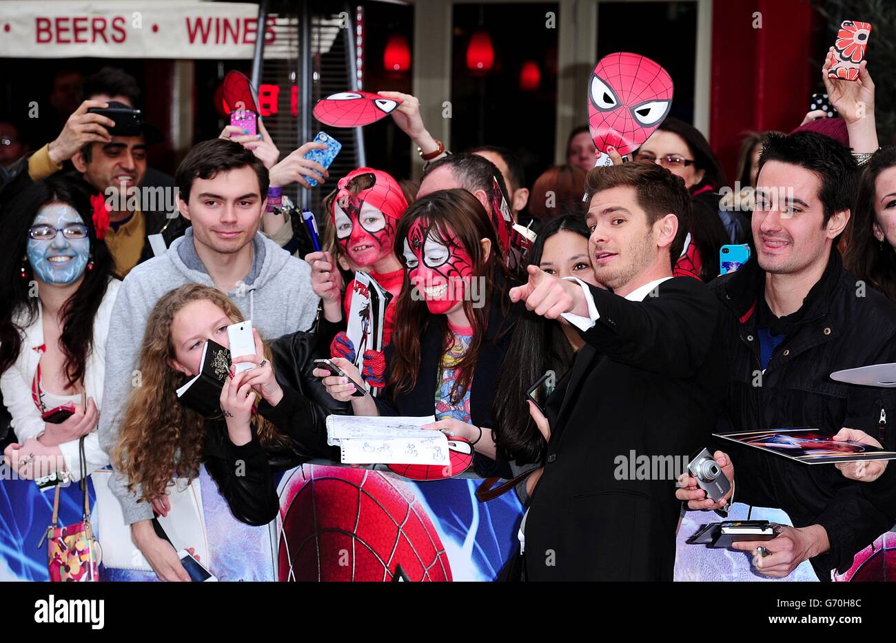 Andrew Garfield takes photographs with fans before the world premiere ...