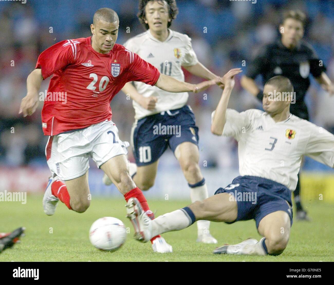 England's Kieron Dyer (left) challenges Keisuke Tsuboi of Japan for the ...