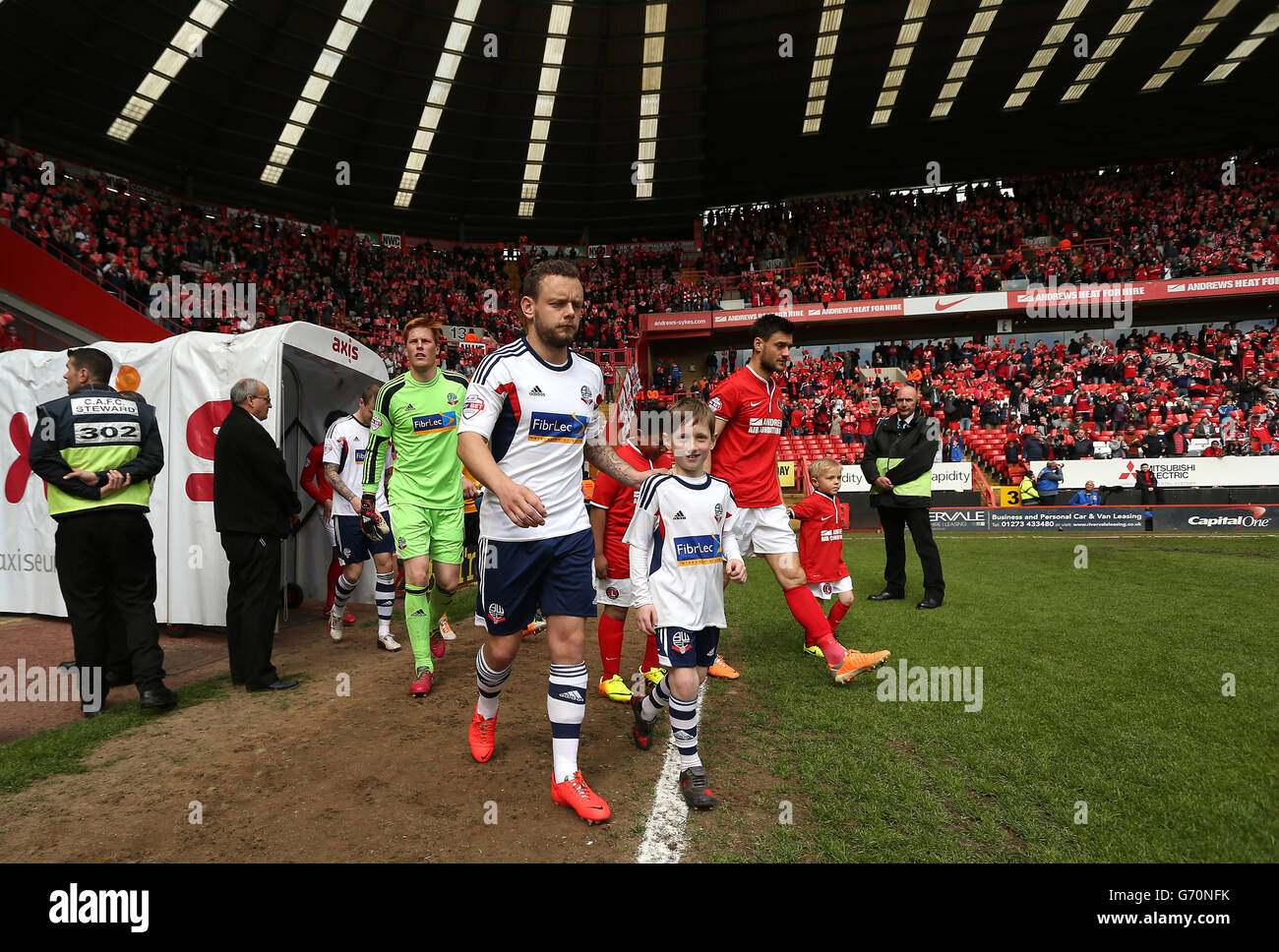 The teams and mascots walk out at the start of the match Stock Photo ...