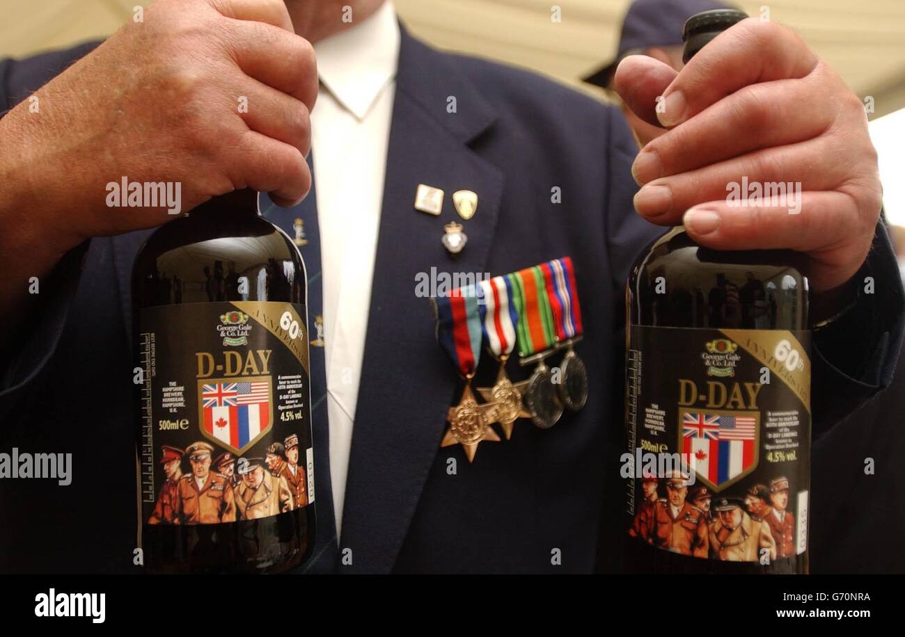 A D-Day veteran clutches two bottles of commemorative beer, brewed for ...