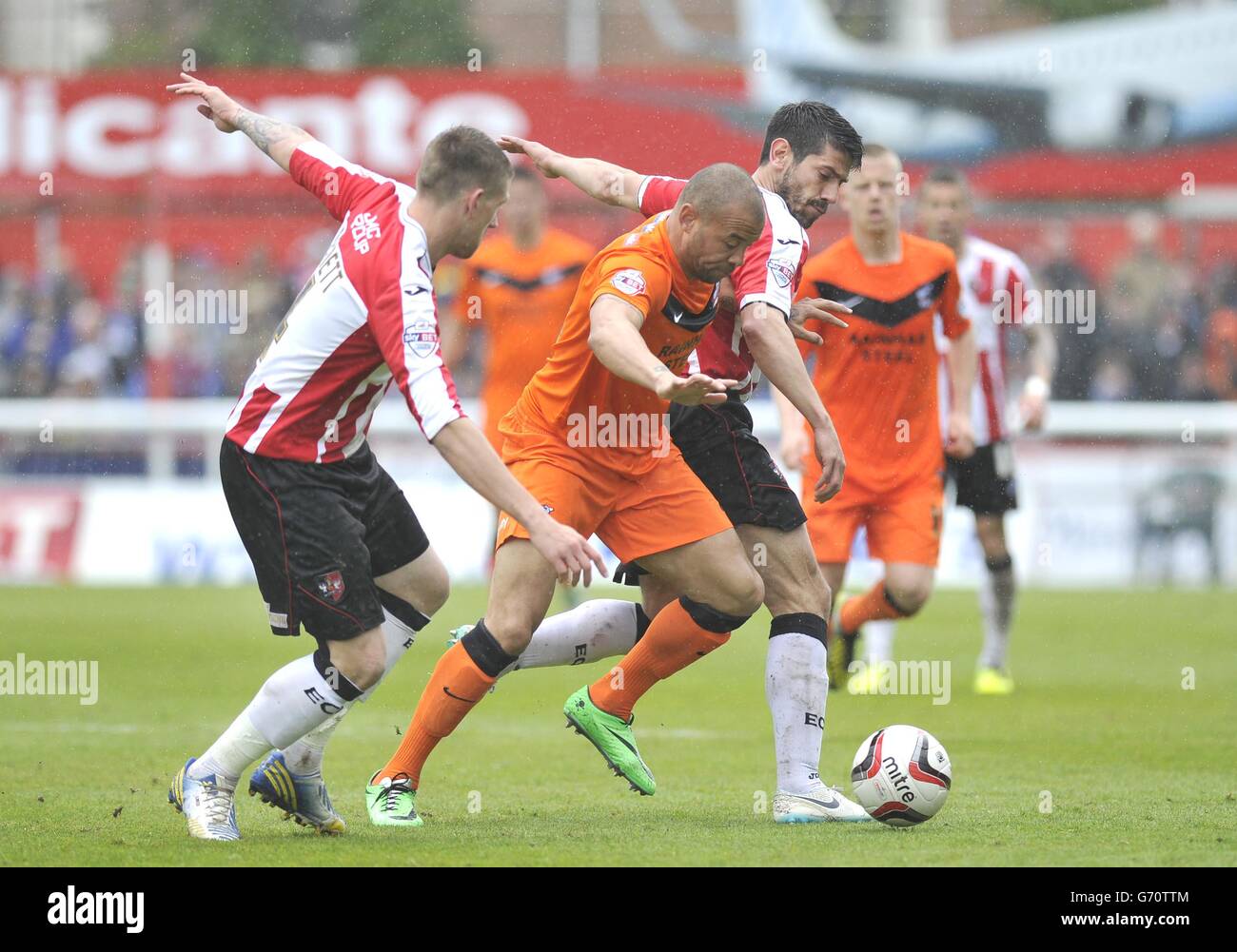 Exeter City's Scott Bennett (left), Scunthorpe United's Deon Burton and ...