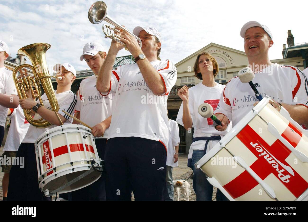 A group of England fans accompanied by the England Supporters band ...