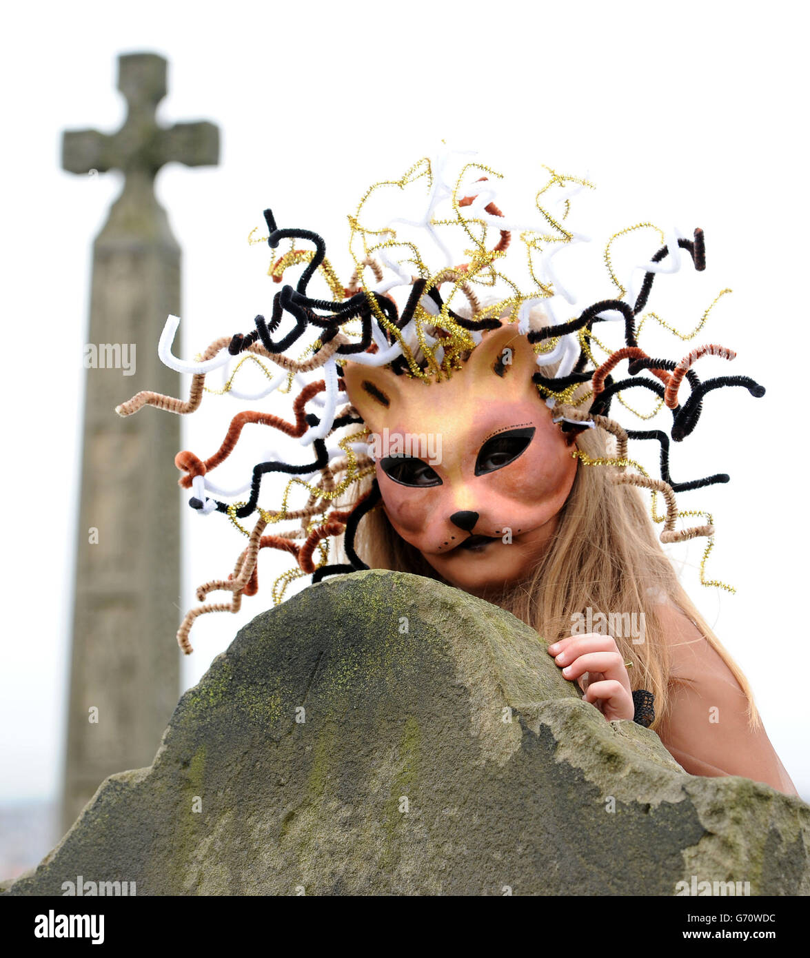 Milian Maddison wears a beast mask in the grounds of St Mary's Church ...