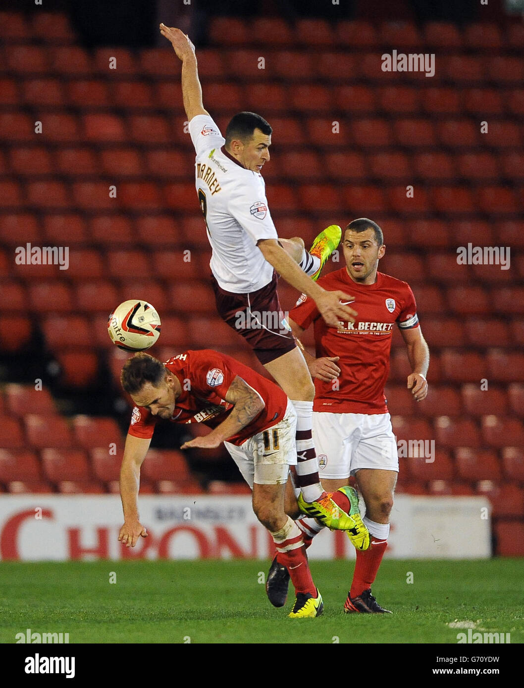Barnsley's Martin Woods (bottom) and Burnley's Dean Marney (top) battle ...