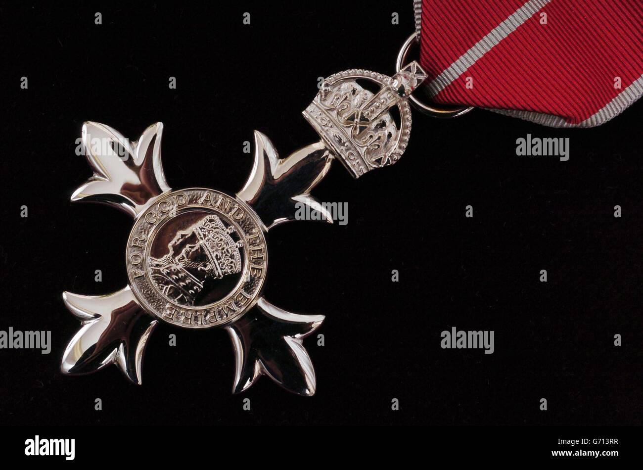 A male Member of the Order of the British Empire (MBE) is photographed ...