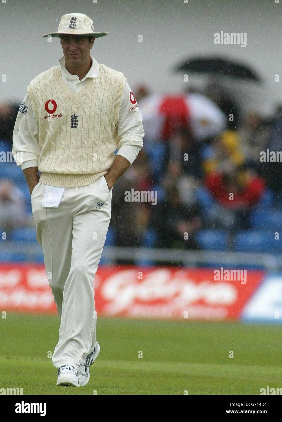 England captain Michael Vaughan leaves the field as the rain comes down ...