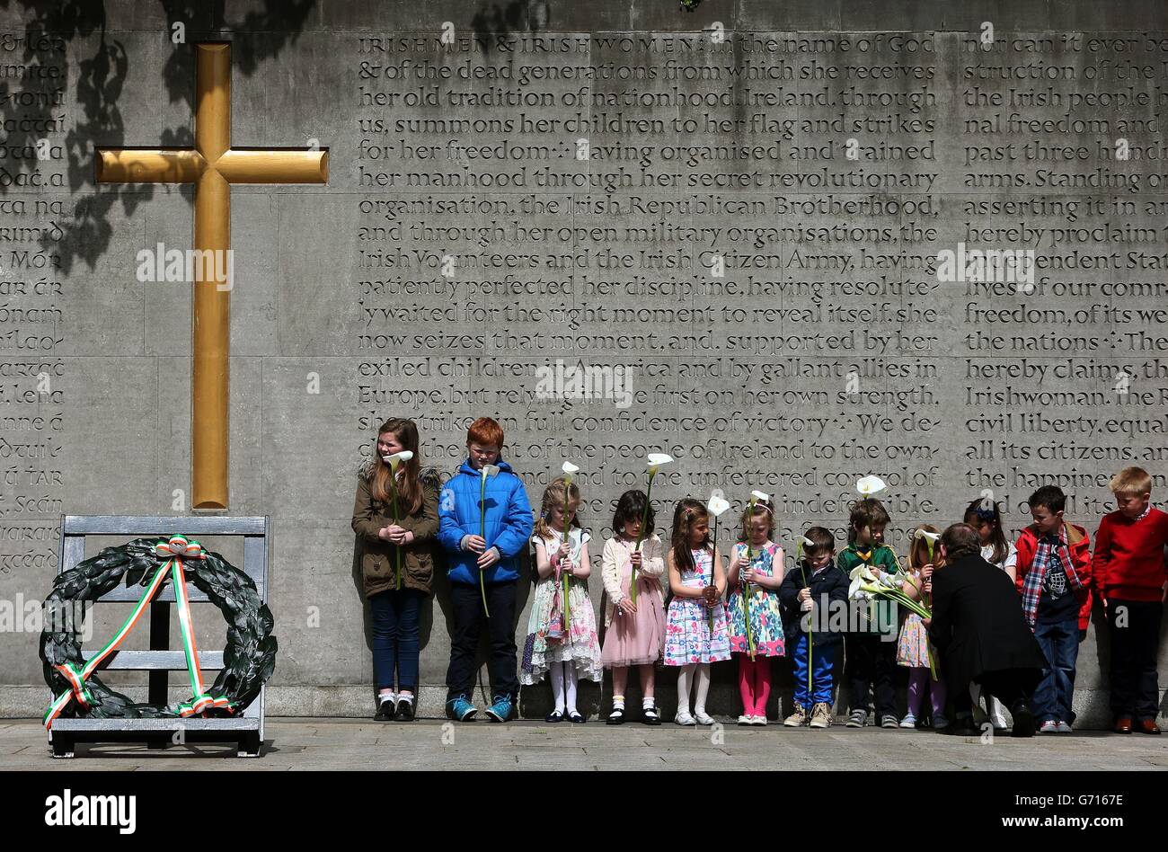 Children wait to place an Easter Lily, a symbol of the 1916 Easter ...