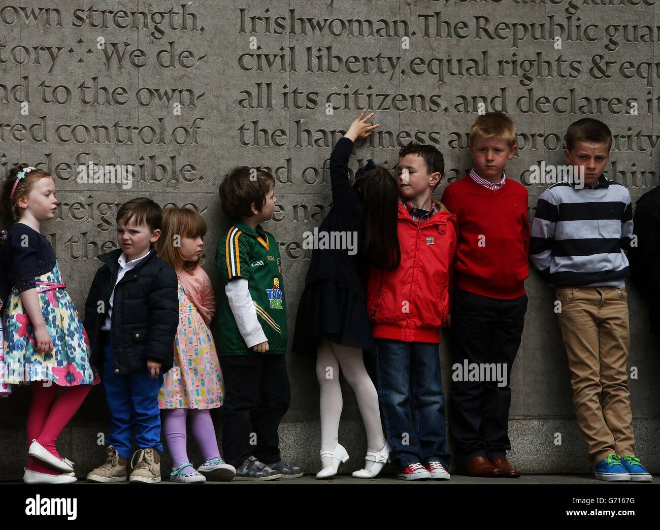 Children wait to place an Easter Lily, a symbol of the 1916 Easter ...