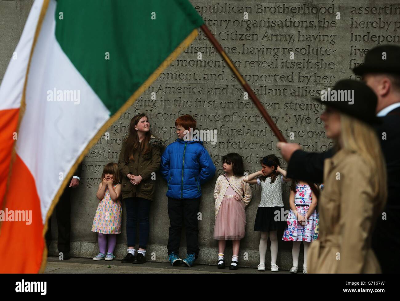 Children wait to place an Easter Lily, a symbol of the 1916 Easter ...