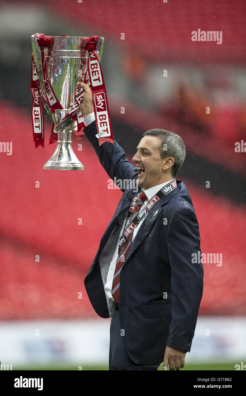 Fleetwood Town chairman Andy Pilley celebrates victory with the trophy ...