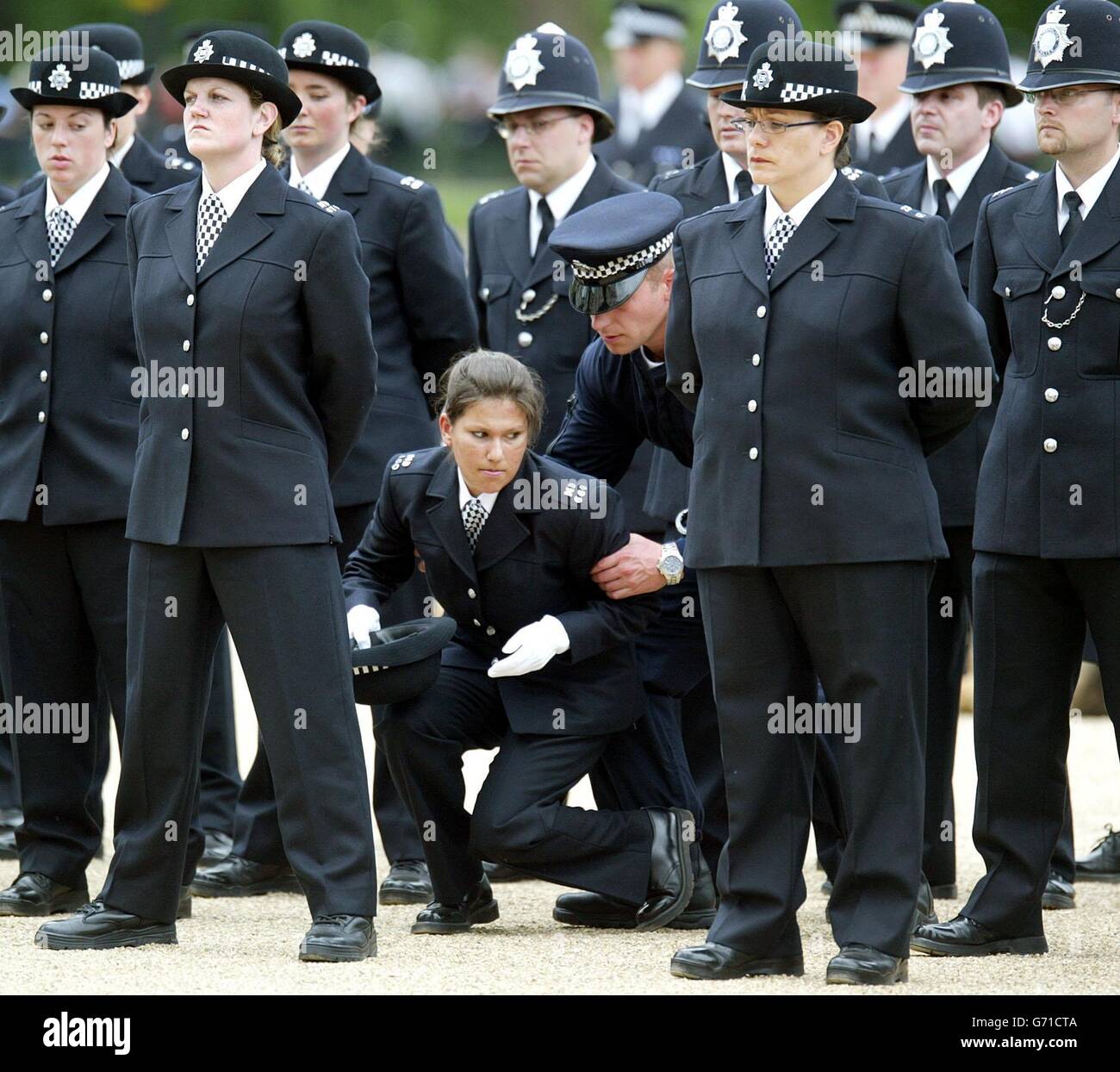 A police officer collapses at a celebration of the Metropolitan Police ...