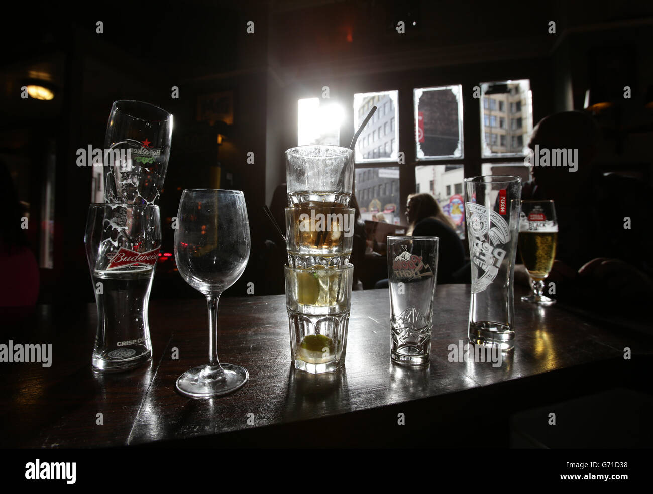 A row of empty drink glasses on the bar at Irish pub O'Neill's in ...
