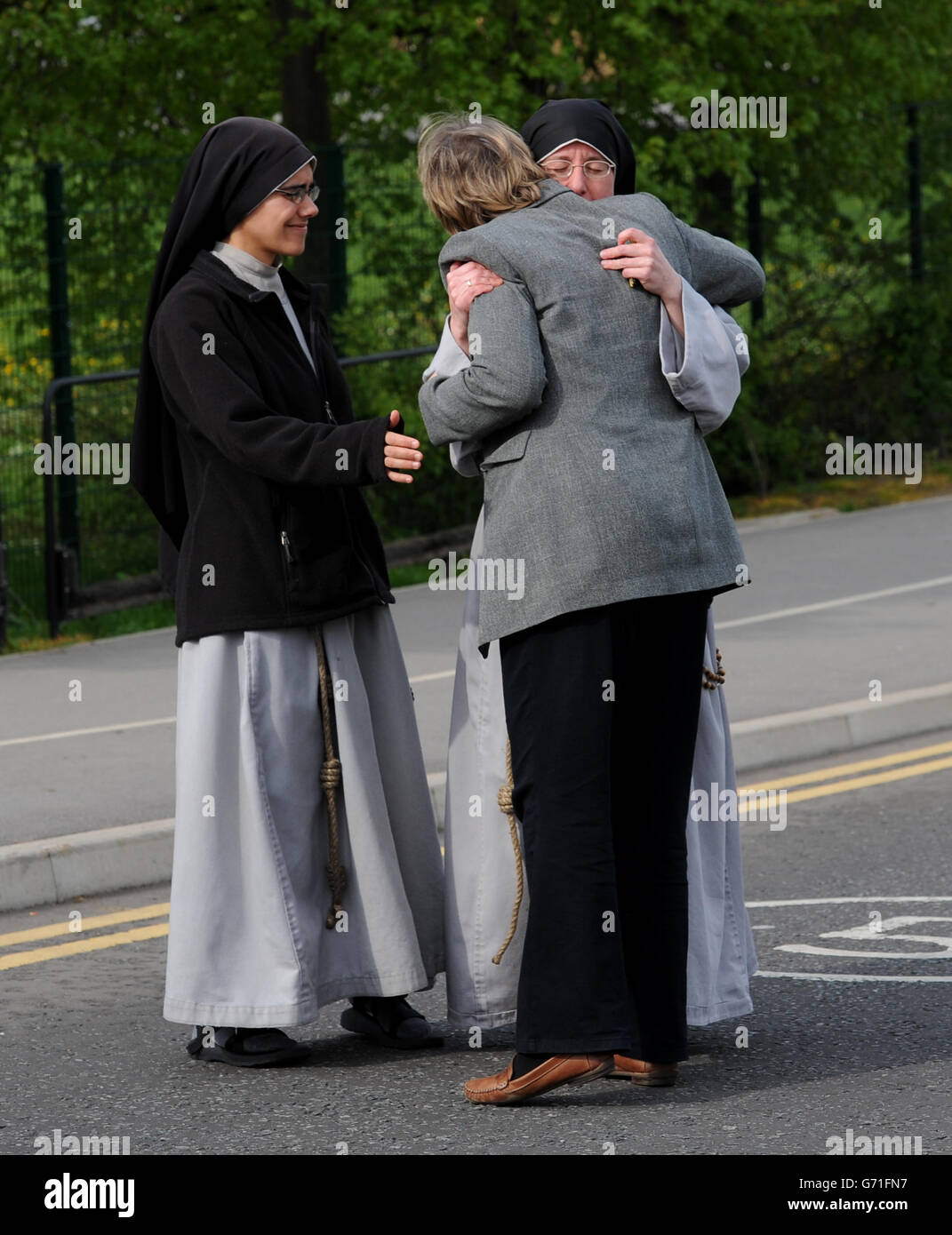 Two nuns comfort a member of the public outside Corpus Christi Catholic ...