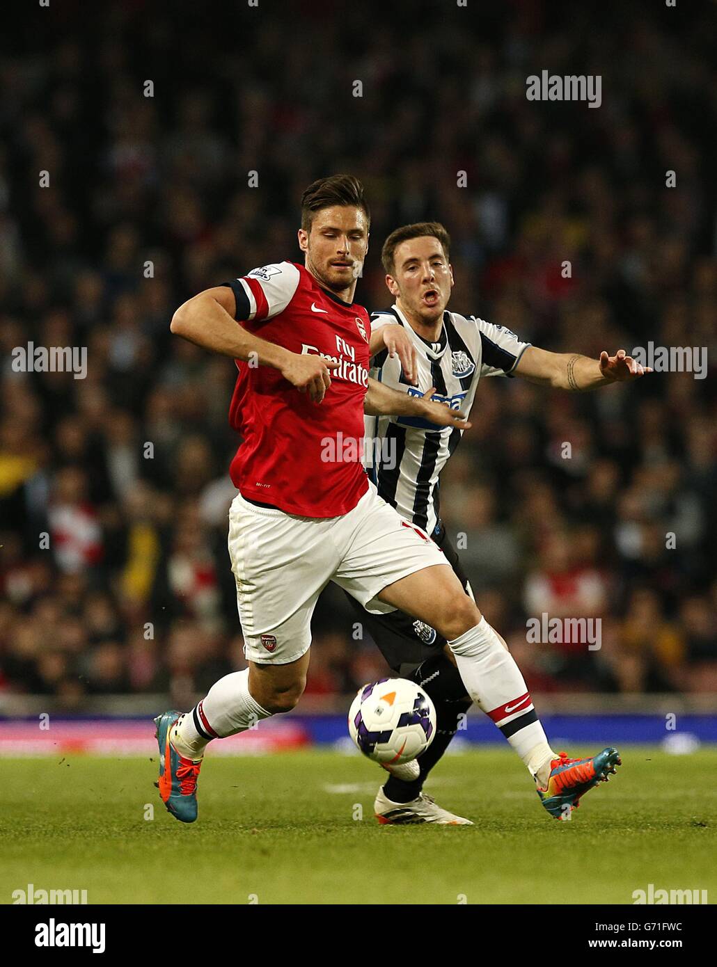 Arsenal's Olivier Giroud (left) and Newcastle United's Dan Gosling ...