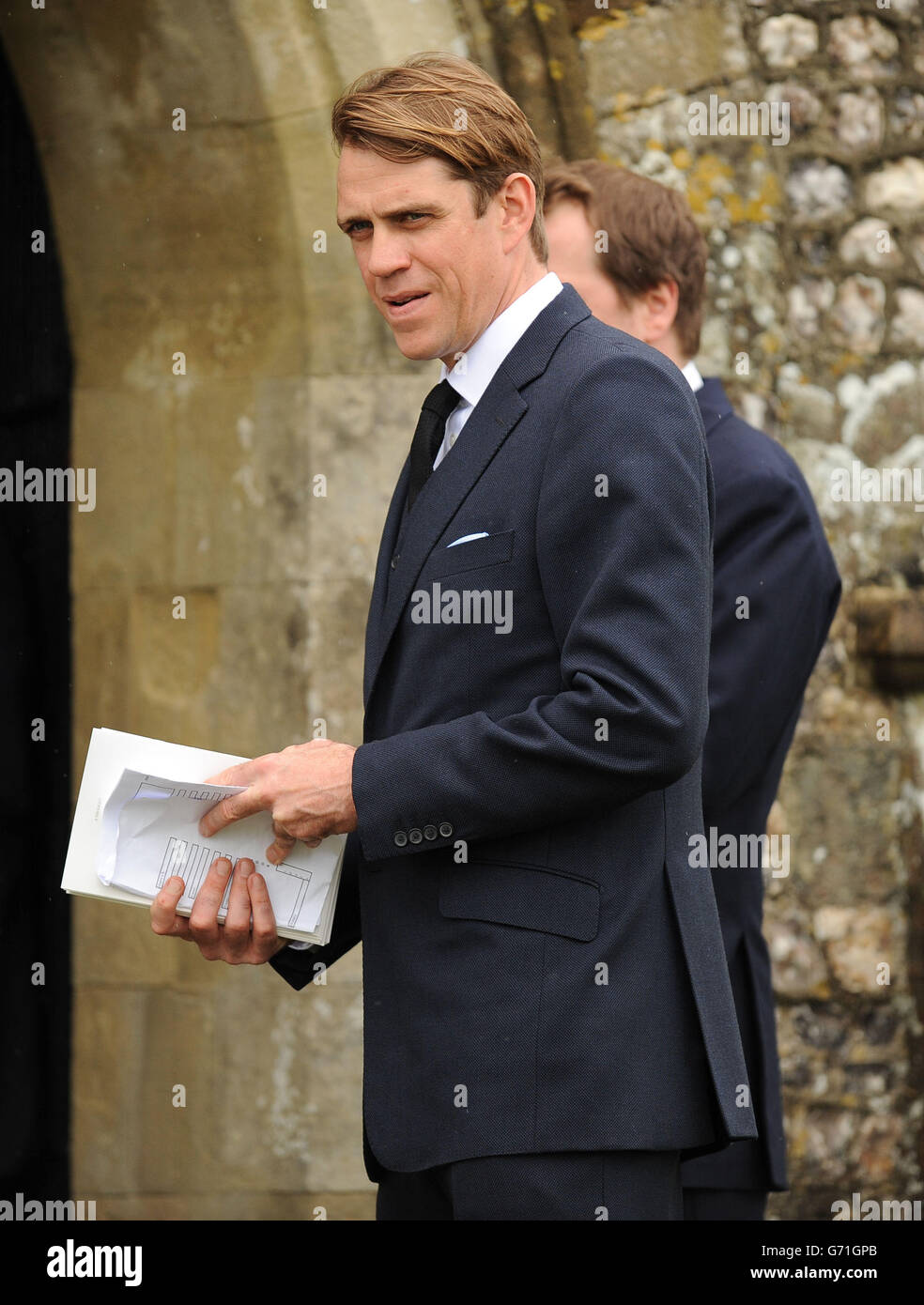Ben Elliot, cousin of Tom Parker-Bowles, greets guests at Holy Trinity ...