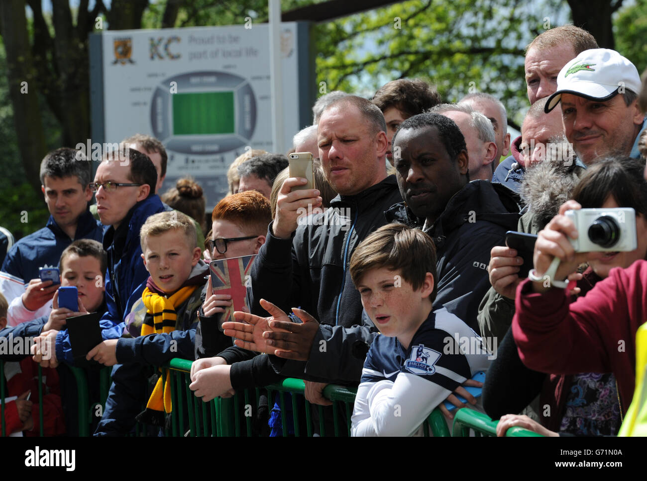 Fans take photos as the Everton team bus arrives ahead of the Barclays ...