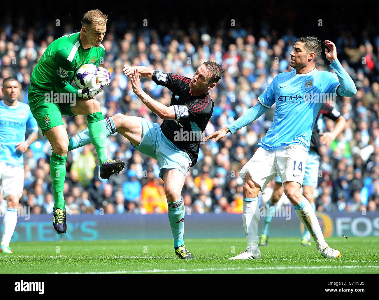 Manchester City's Joe Hart (left) battles for the ball with West Ham ...