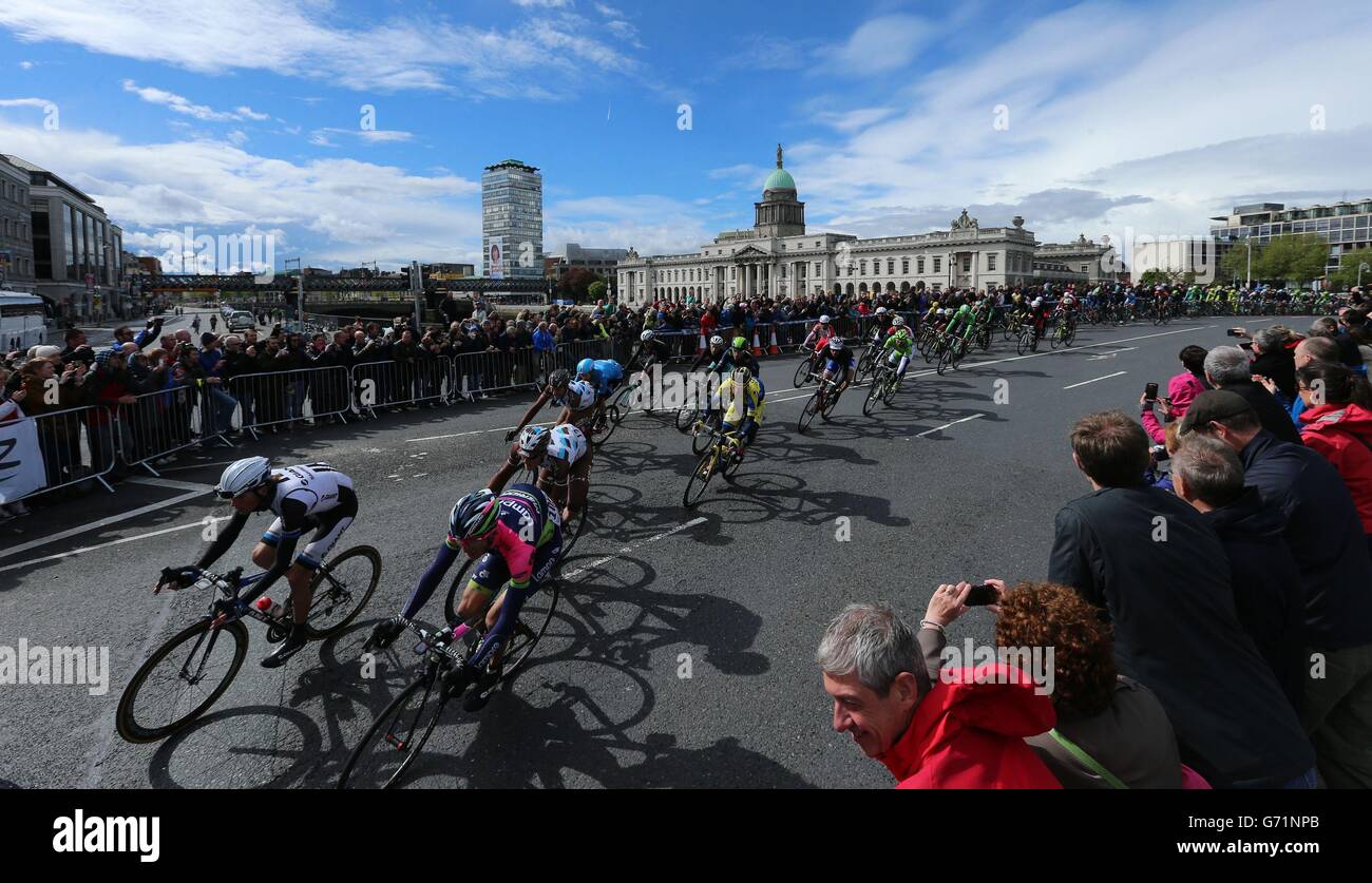 The Peloton travels across Matt Talbot Bridge past the Customs house ...