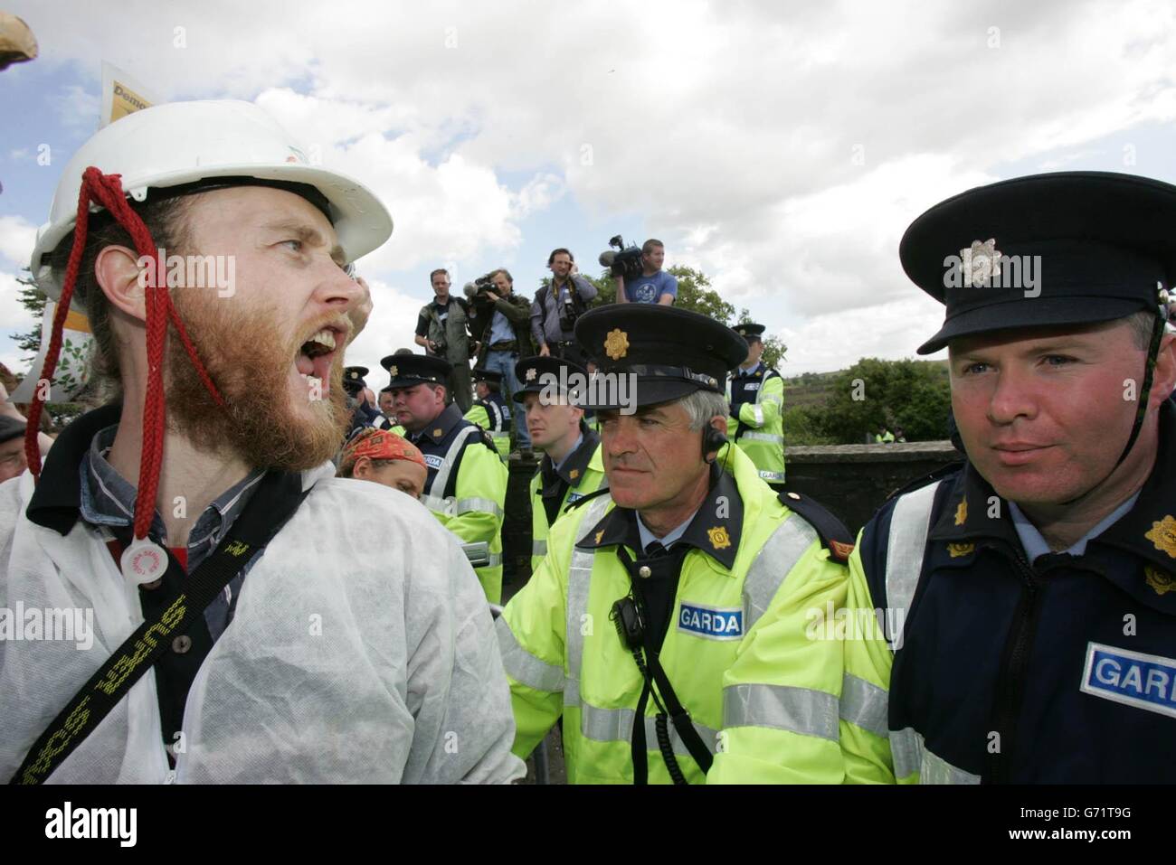 Irish Police hold back a protestor outside Dromoland Castle in Co Clare ...