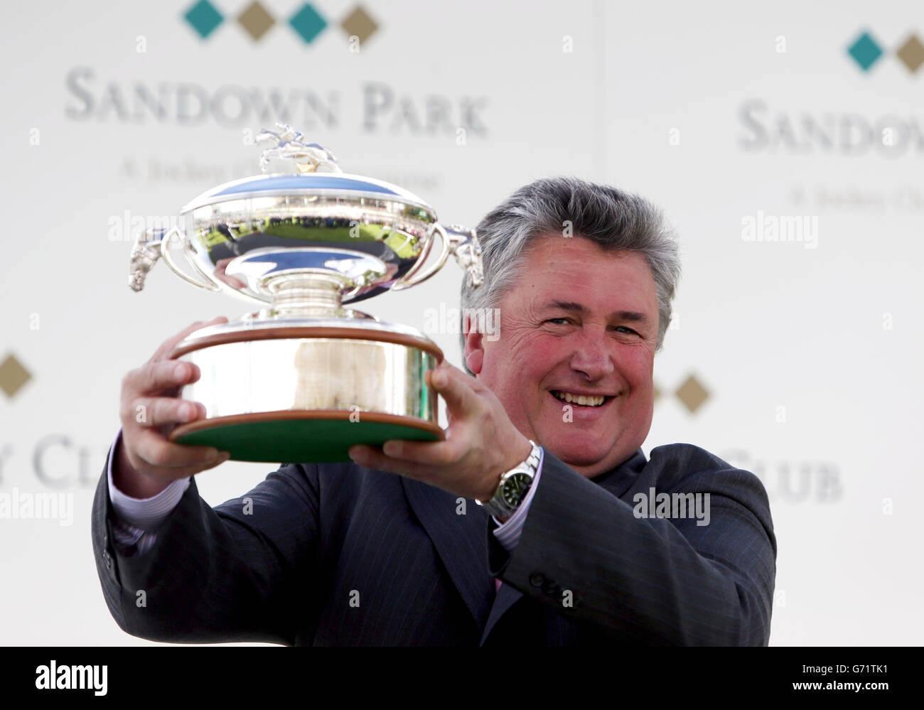Paul nicholls presented champion trainers trophy jump finale sandown ...