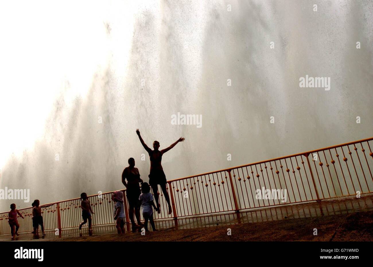 Cooling off in the fountain Stock Photo - Alamy