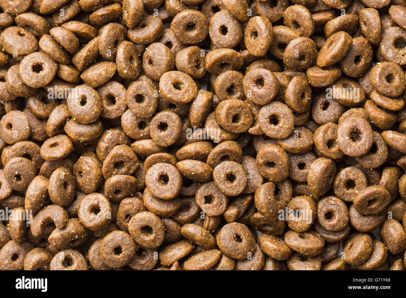 Dry kibble dog food background Stock Photo - Alamy