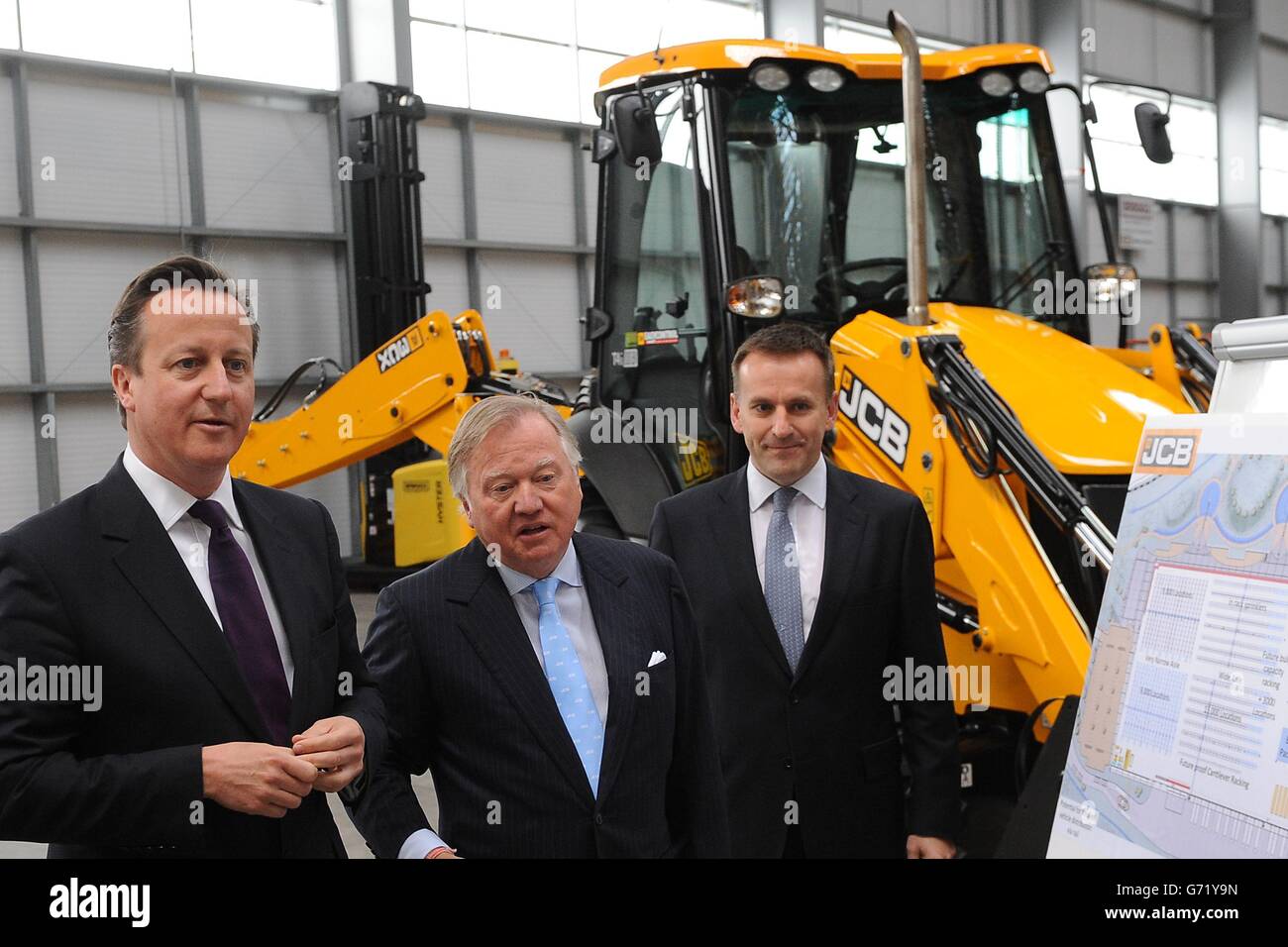 Prime Minister David Cameron is given a tour by Lord Anthony Bamford ...