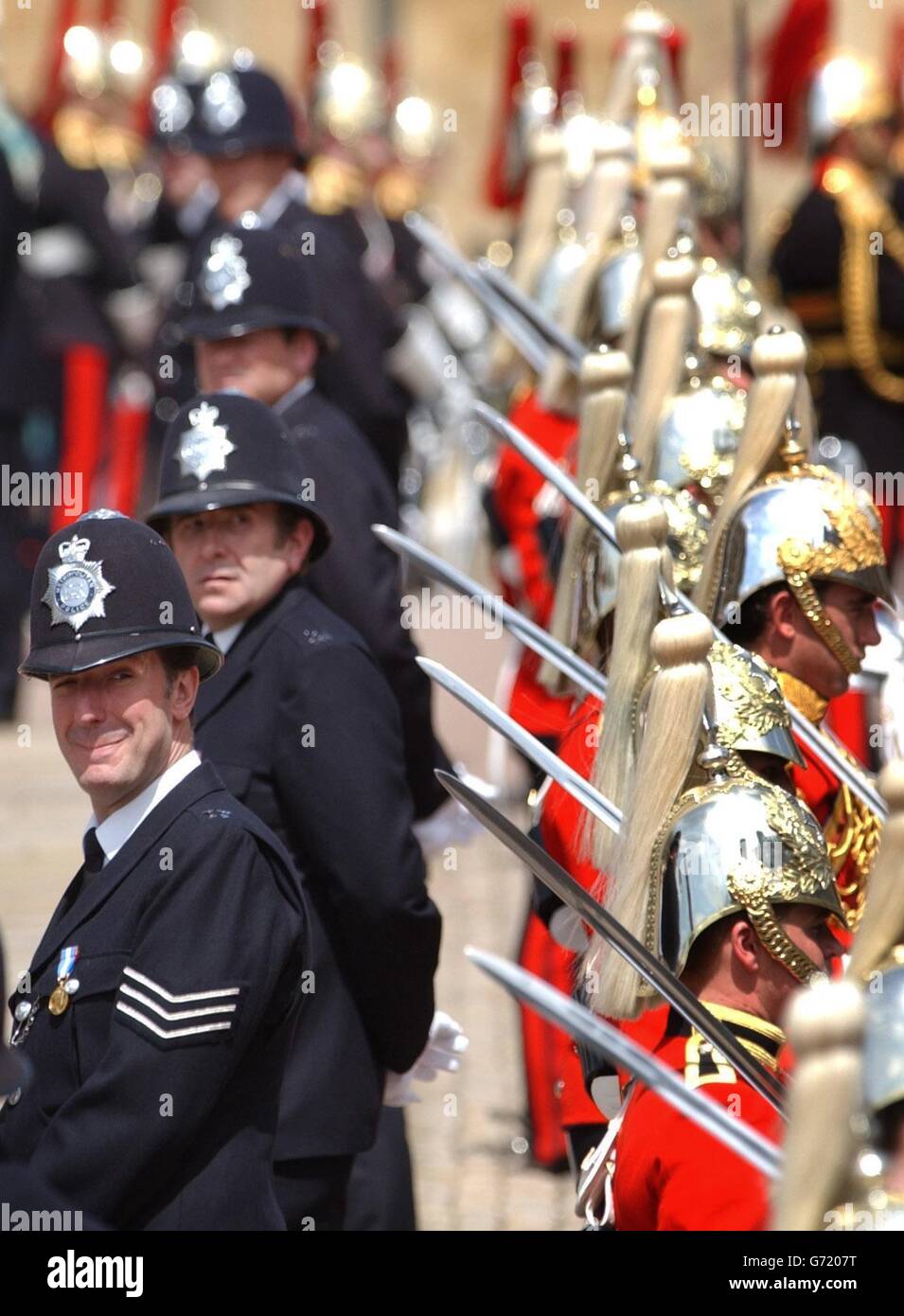 Policemen line up alongside Lifeguards from the Household Cavalry ...
