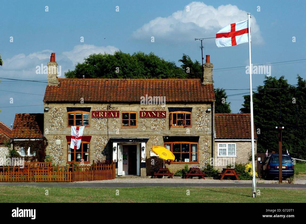 Pub flies flag at half mast Stock Photo - Alamy