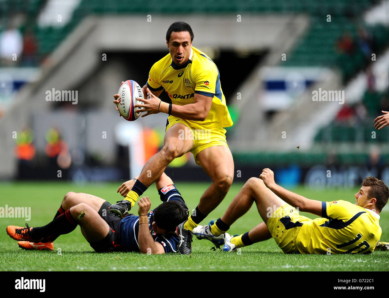 Australia's Lausii Taliauli jumps over a Japanese defender during Match ...