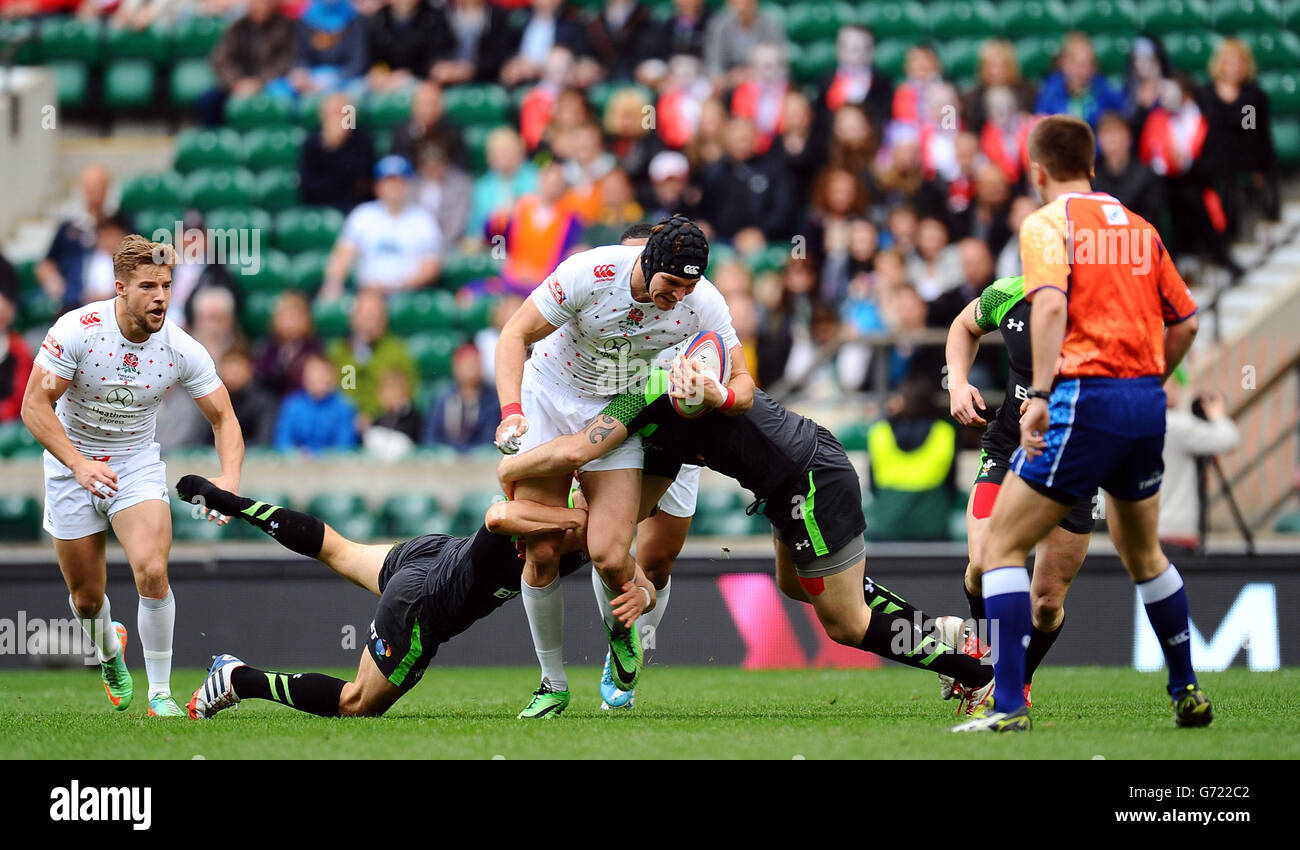 England's Tom Powell (centre) runs between two Welsh defenders during ...