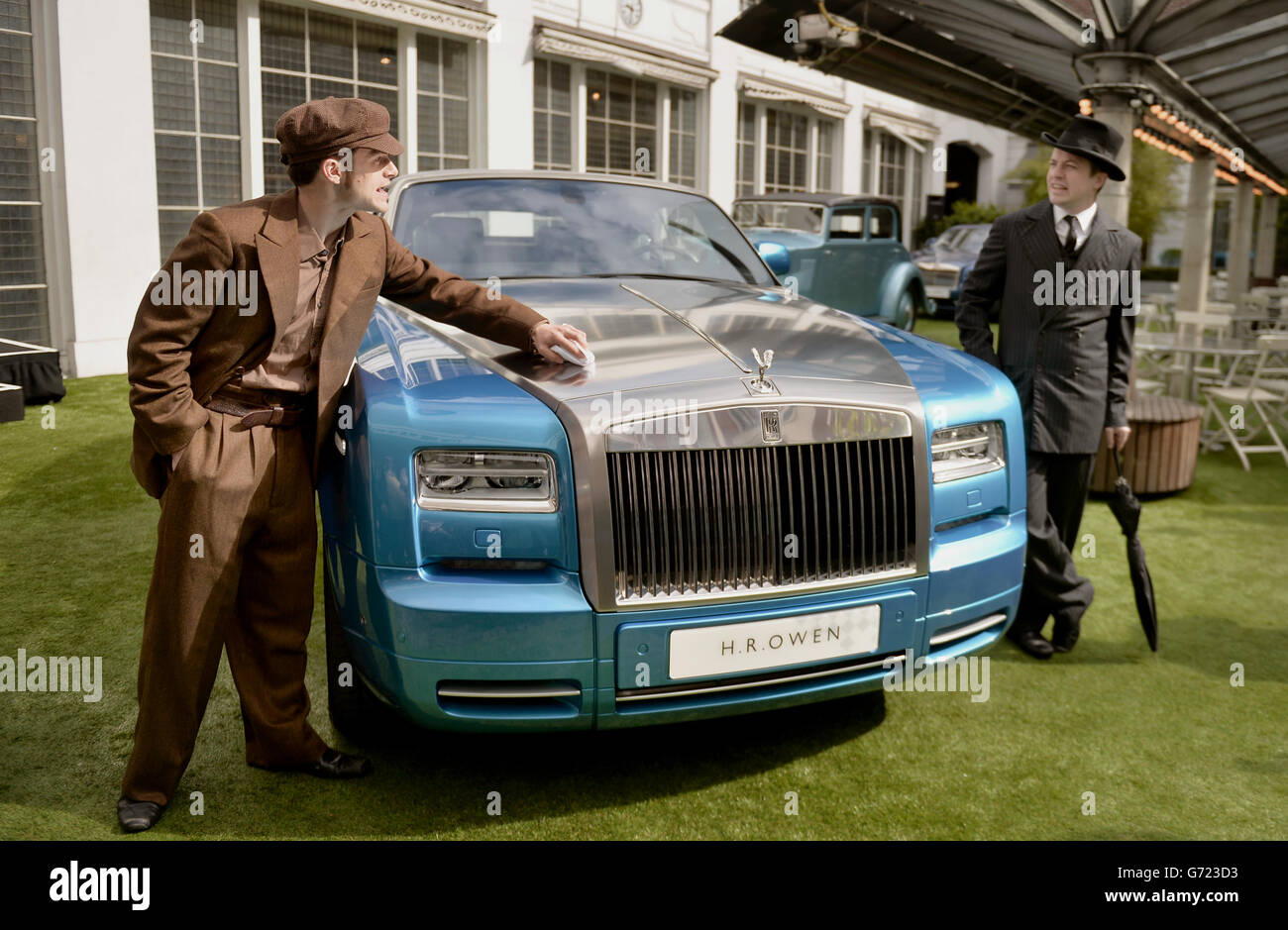 Actors dressed in period costume pose beside the new Rolls Royce ...