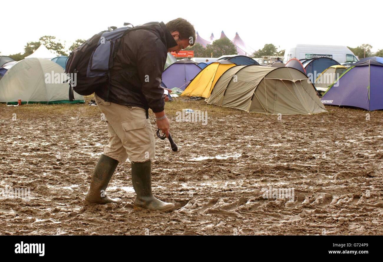 A sound recordist tapes squelching in mud Stock Photo - Alamy